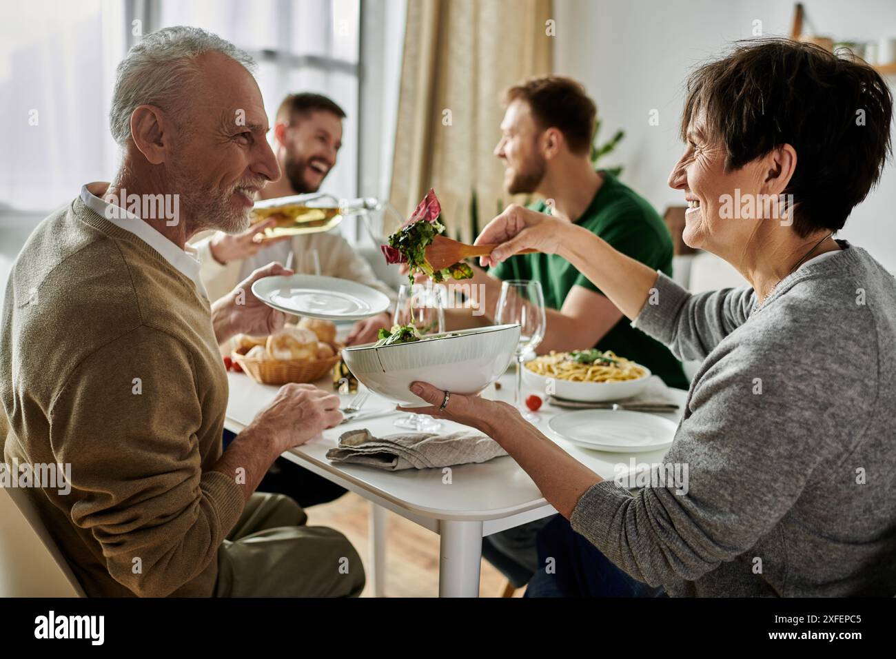 A gay couple enjoys dinner with parents, showcasing a heartwarming ...