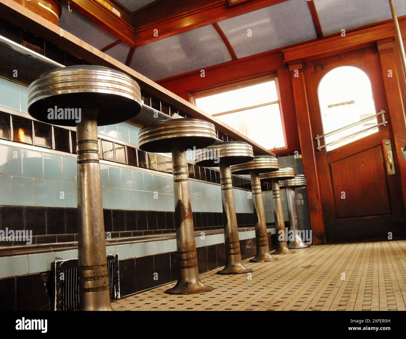 The Interior of an small town American diner with the classic stools up ...