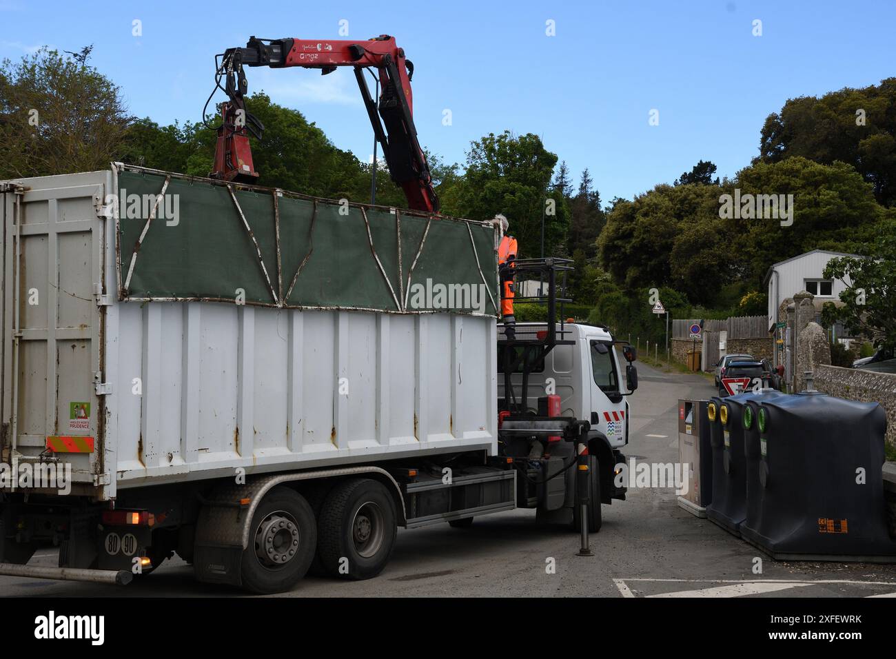 used glass container is emptied using a lorry with a crane attachment ...