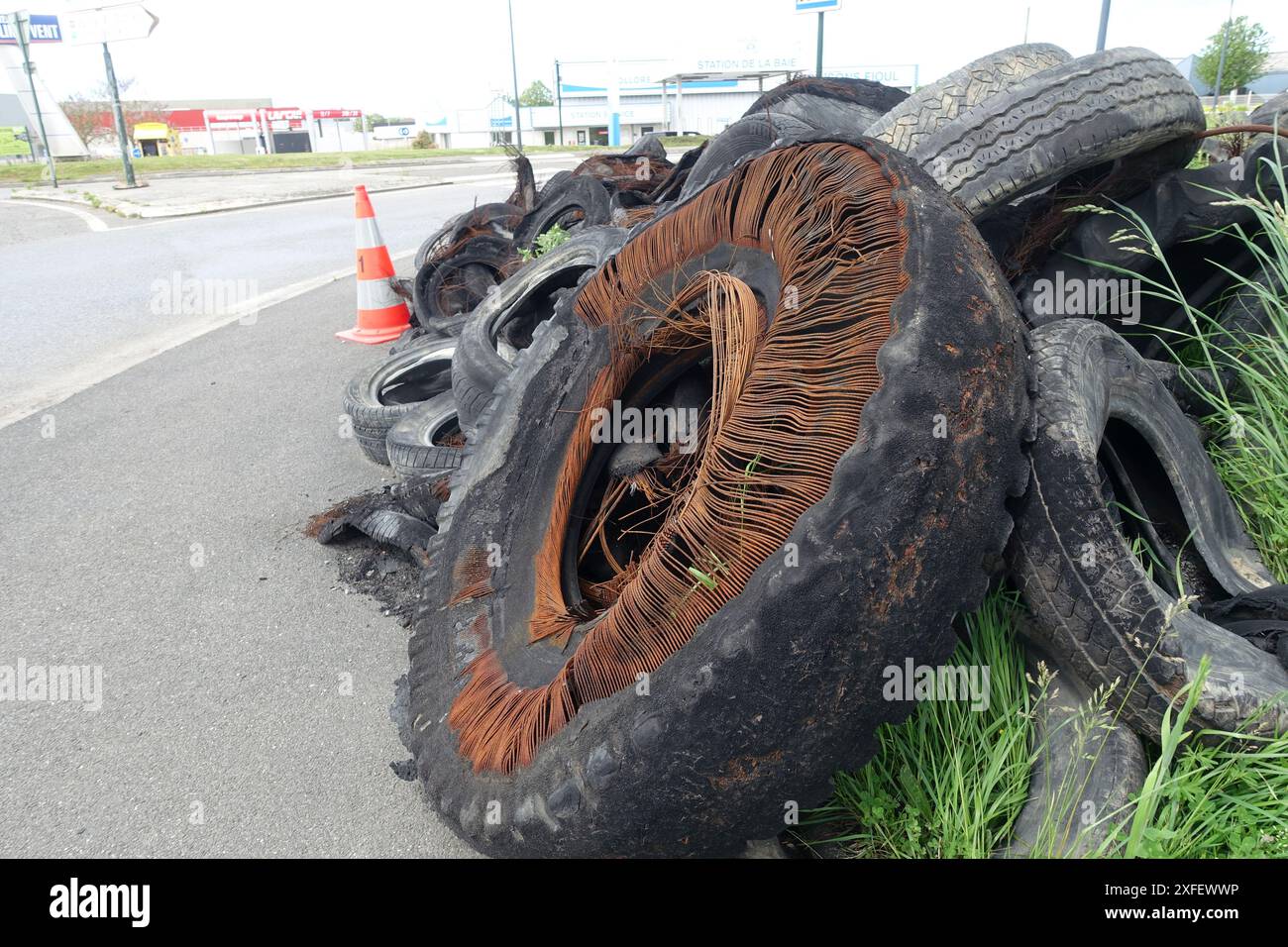 burnt car tyres after a roadside blockade by farmers, France, Brittany ...