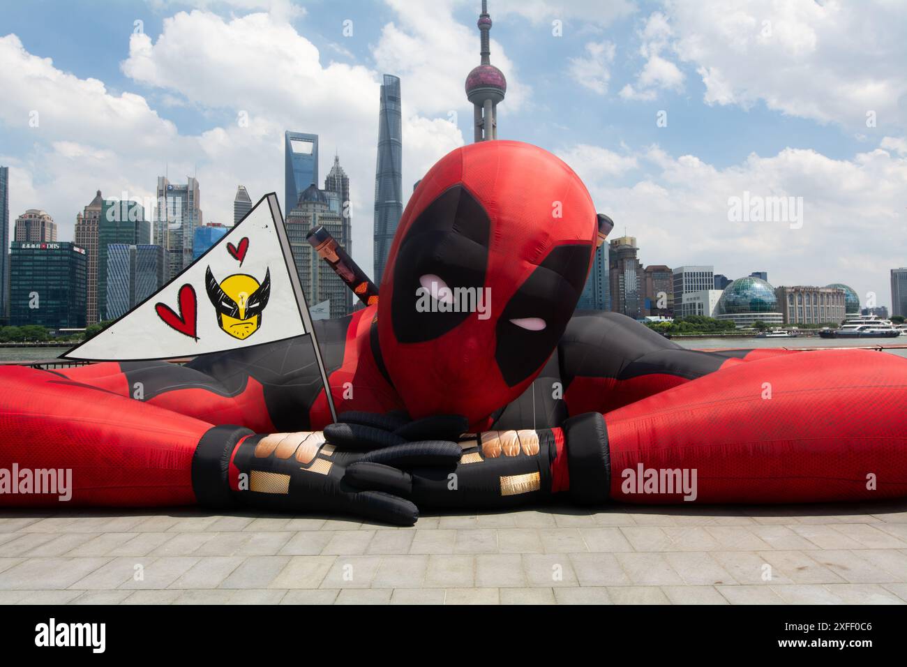 A large figure of an air balloon featuring Wolverine and Deadpool is ...