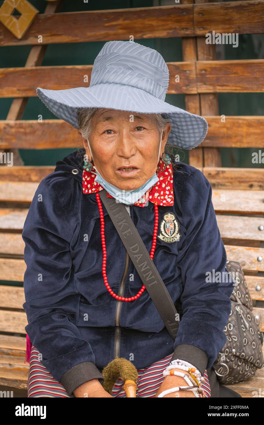 LHASA, TIBET, CHINA - JULY, 17 2022: Old tibetan woman in traditional ...