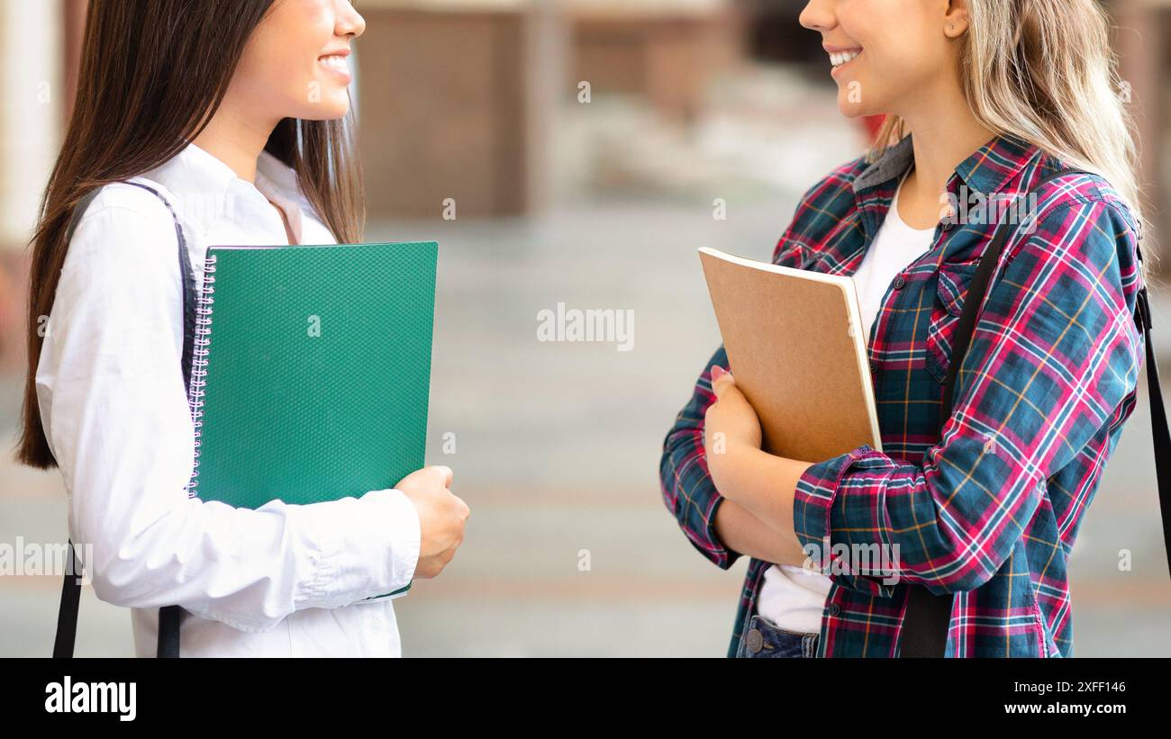 Rest between lectures. Girls talking outdoors after class Stock Photo ...