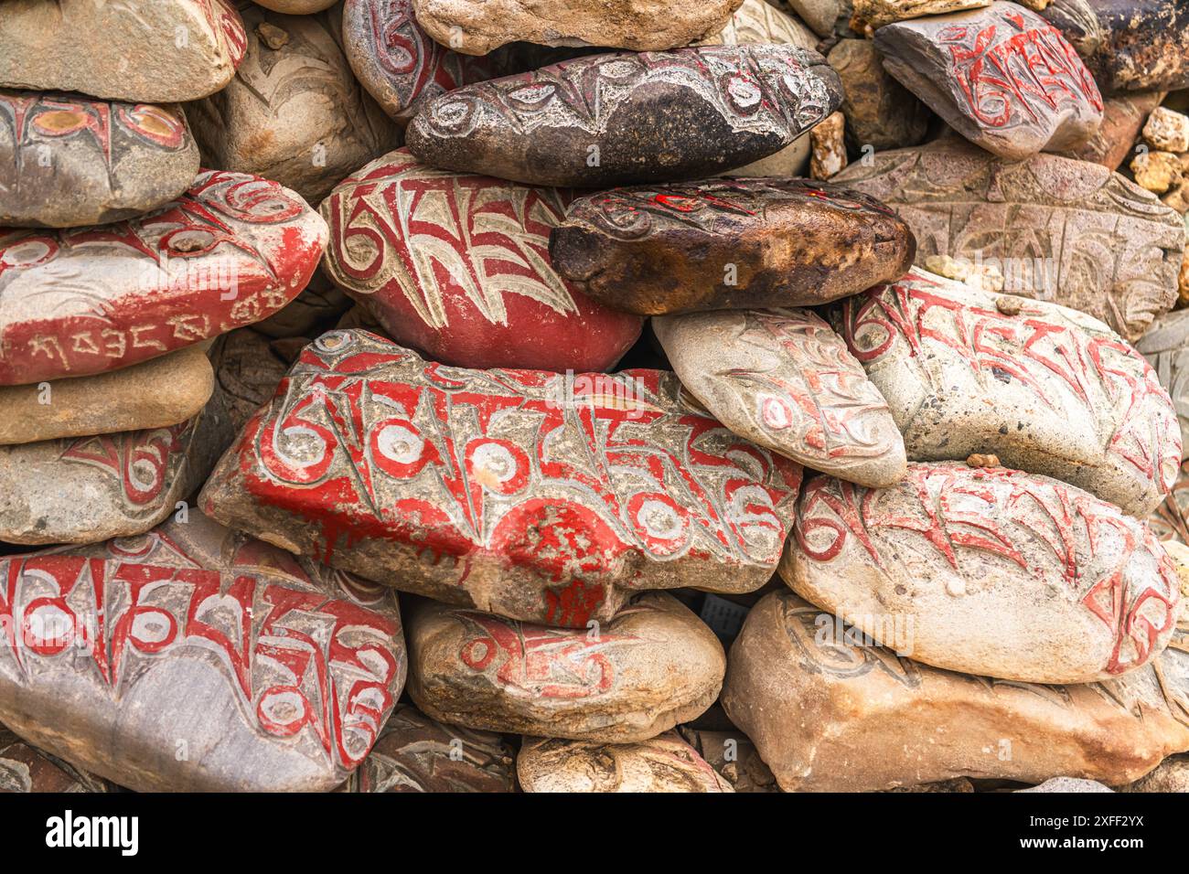 Mani stones with buddhist mantra Om Mani Padme Hum engraved in Tibetan ...