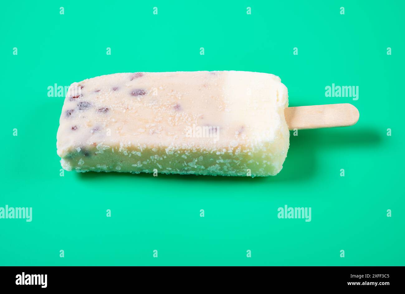 angle view milkshake flavor popsicle with red beans on green background ...
