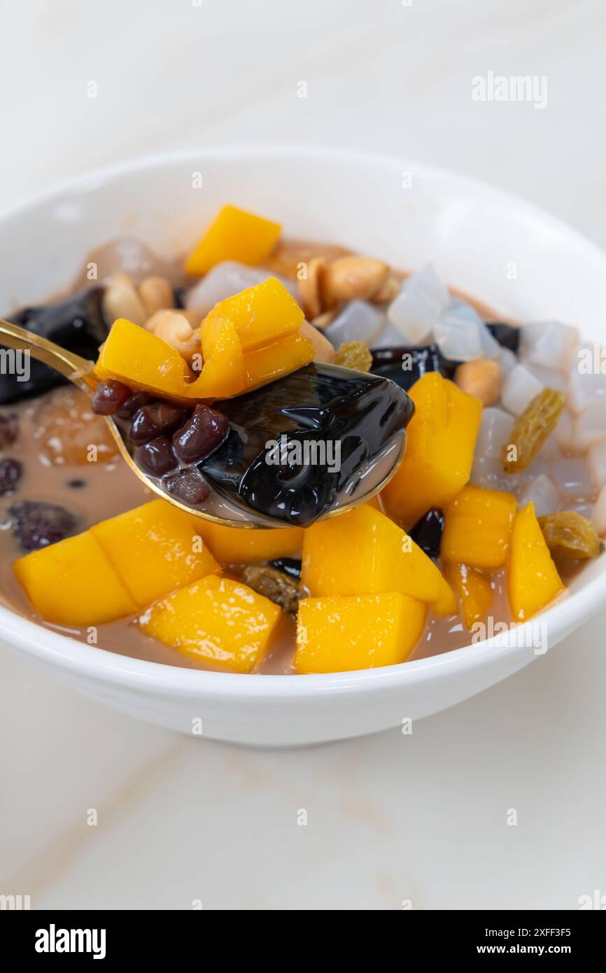 angle view bowl of milktea flavor syrup mixed with grass jelly and ...
