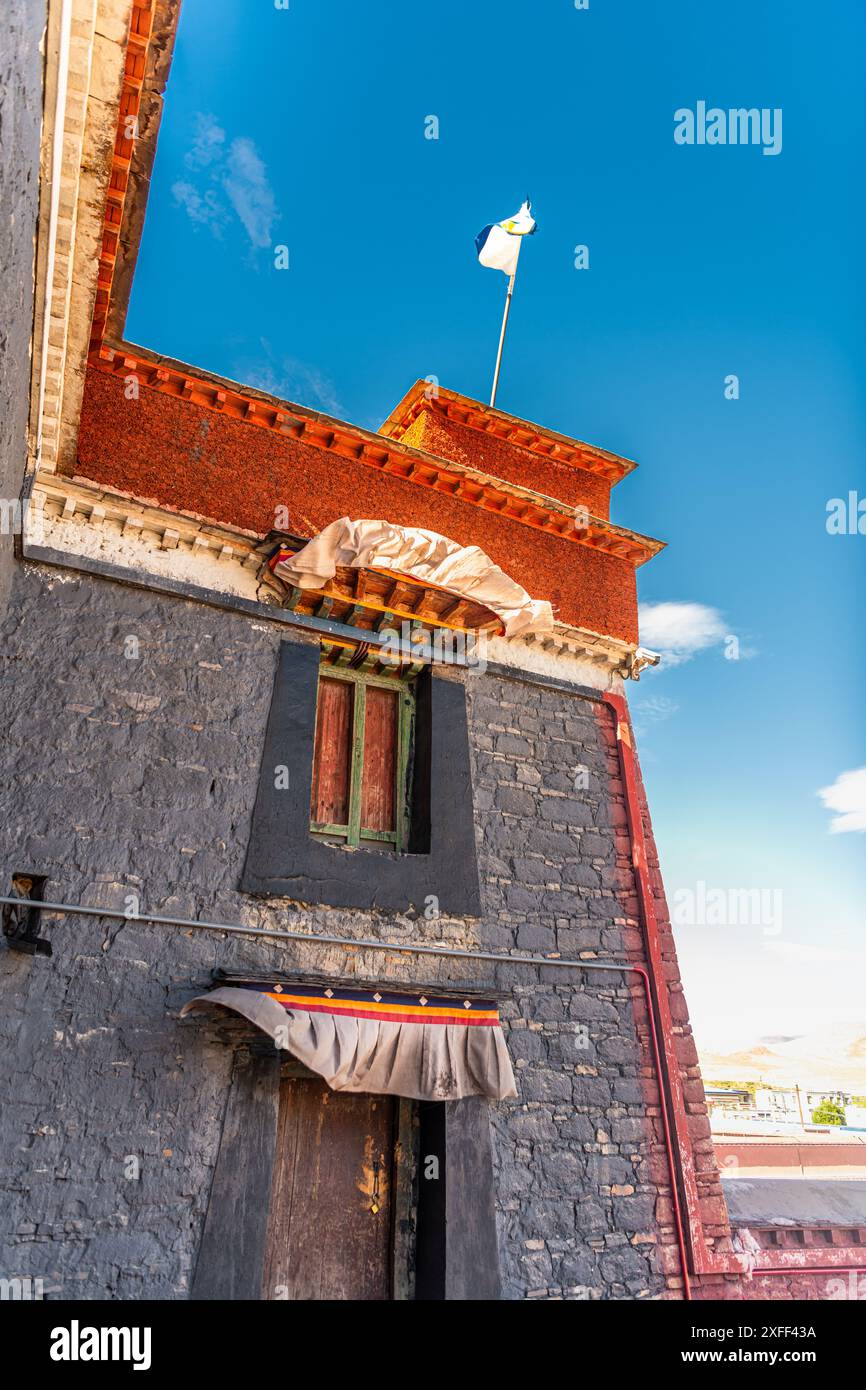 Explore the iconic red, gray, and white facade of Sakya Monastery in ...