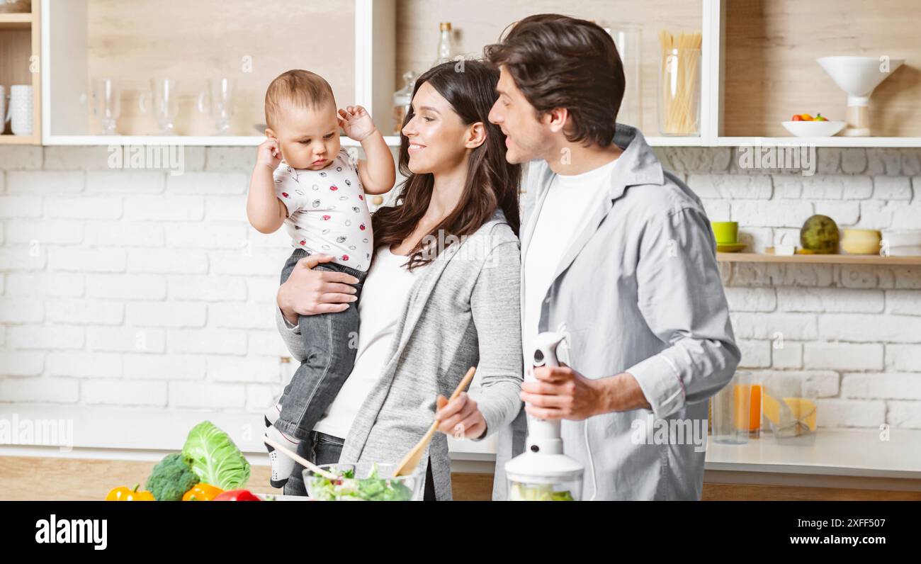 Happy Family Preparing Food Together In Their Kitchen Stock Photo - Alamy