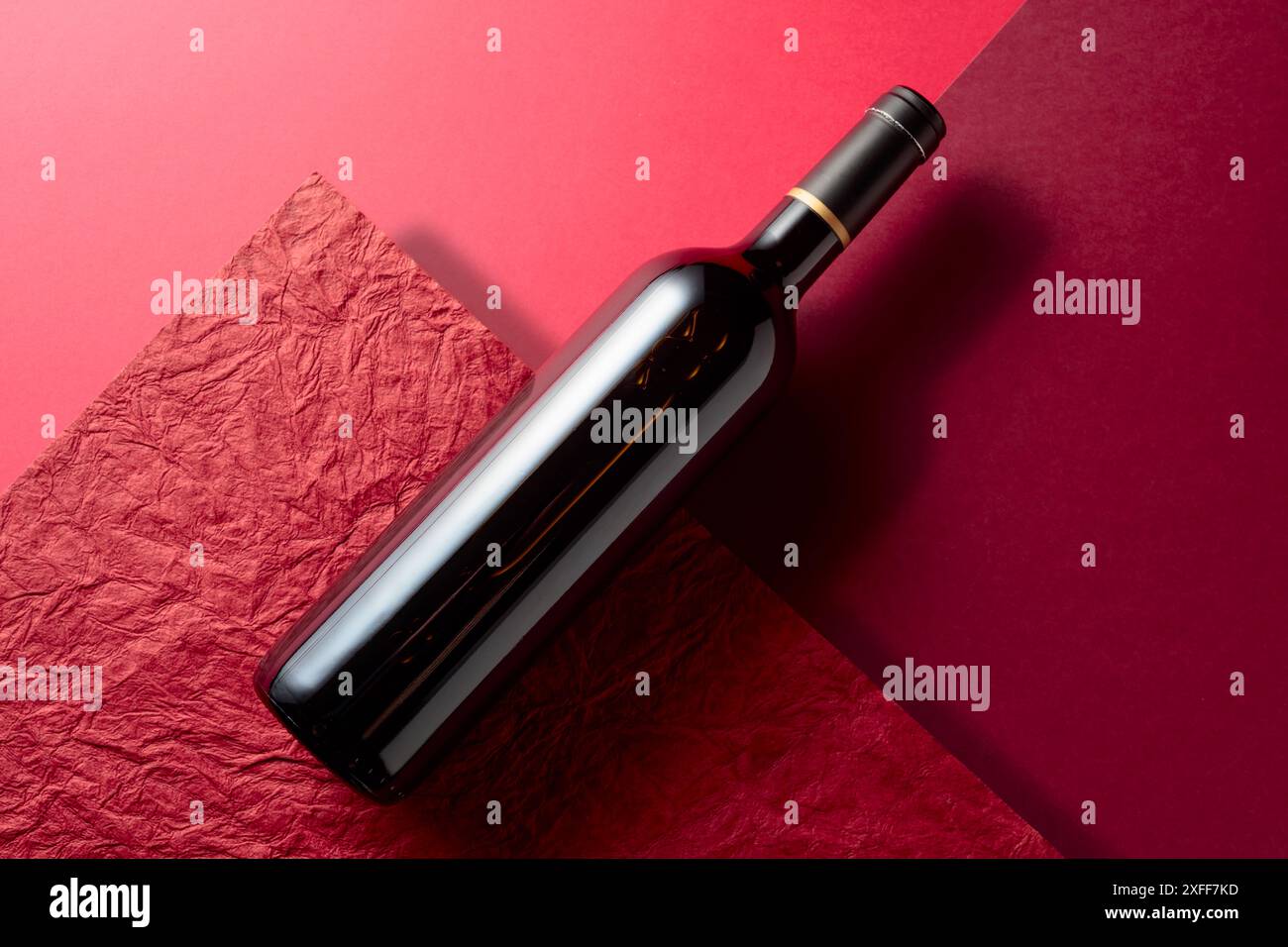 Bottle of red wine on a red background. Red background with different ...