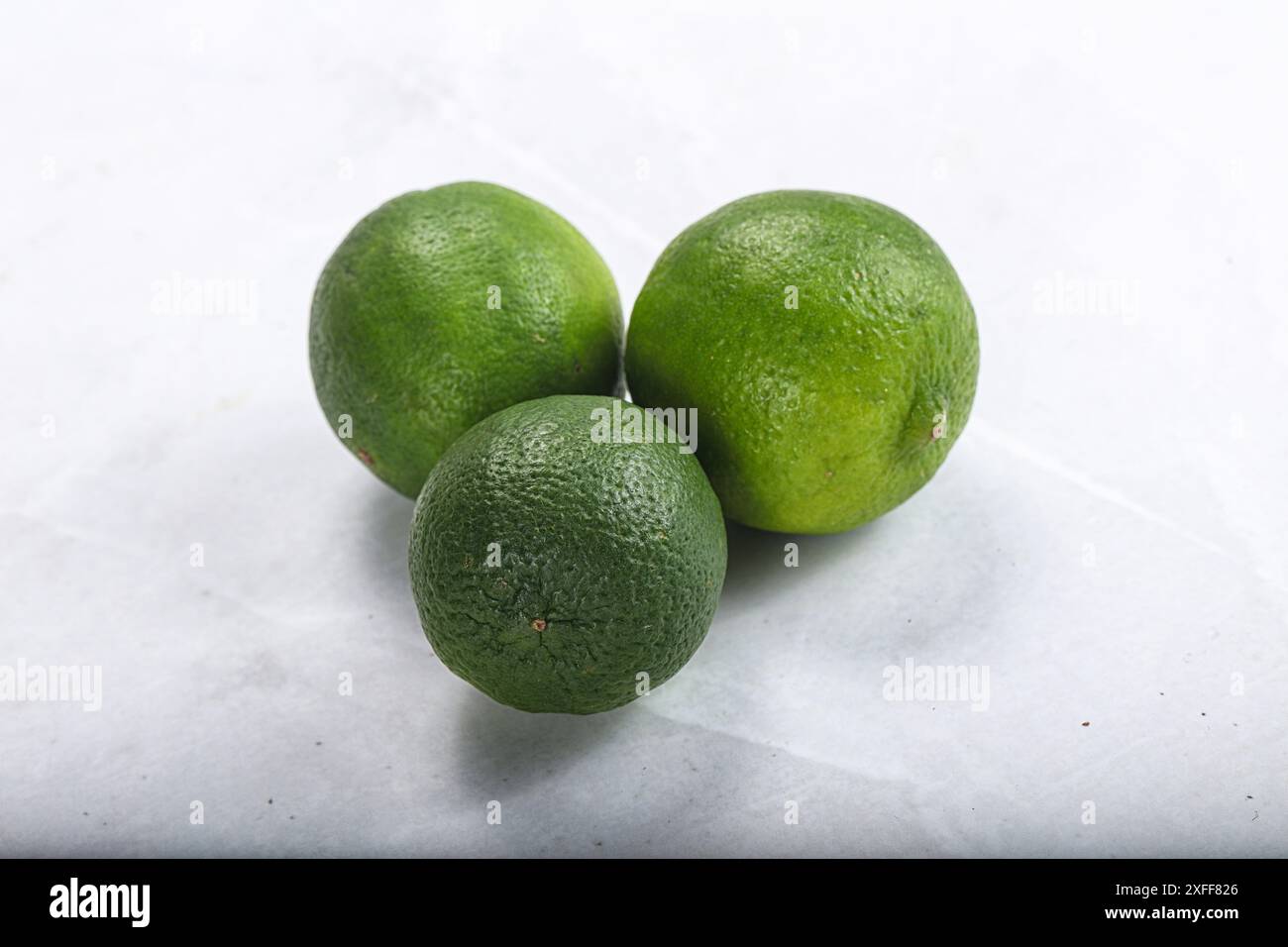 Green sour tropical Lime fruit heap Stock Photo - Alamy