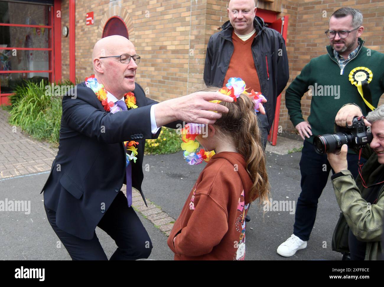 Scottish First Minister and SNP leader John Swinney (left) presents a ...
