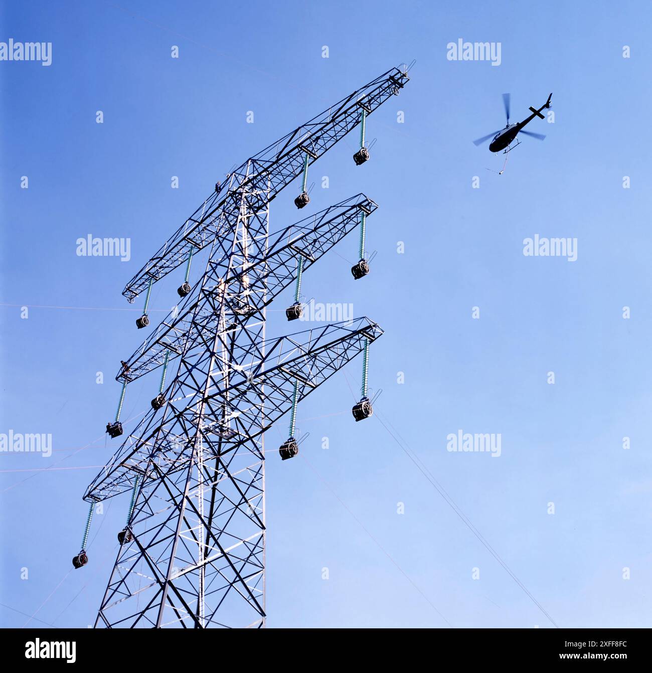 Contractors installing high voltage transmission towers to carry ...