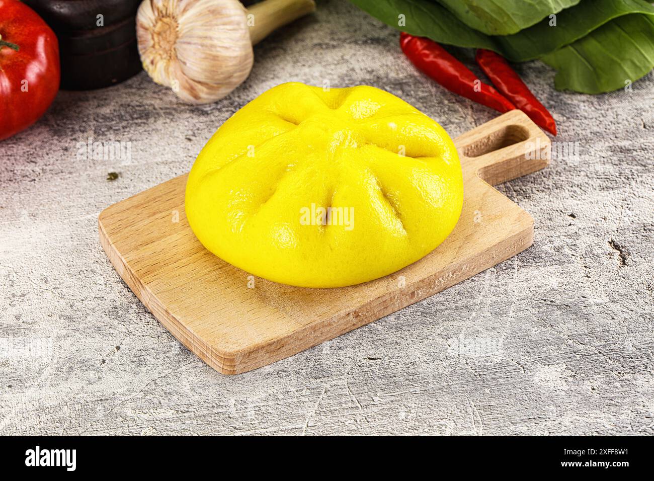Asian stuffed steamed yellow Bun Bao Stock Photo - Alamy