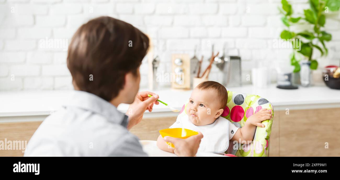 Man feeding baby high chair hi-res stock photography and images - Alamy
