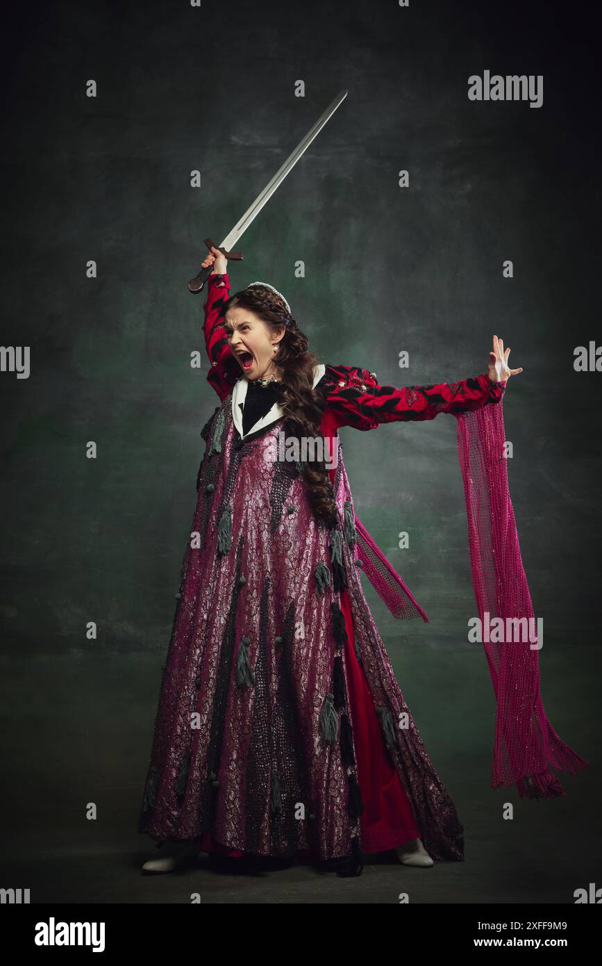 Woman in Renaissance-style gown, holding sword and shouting, exuding ...