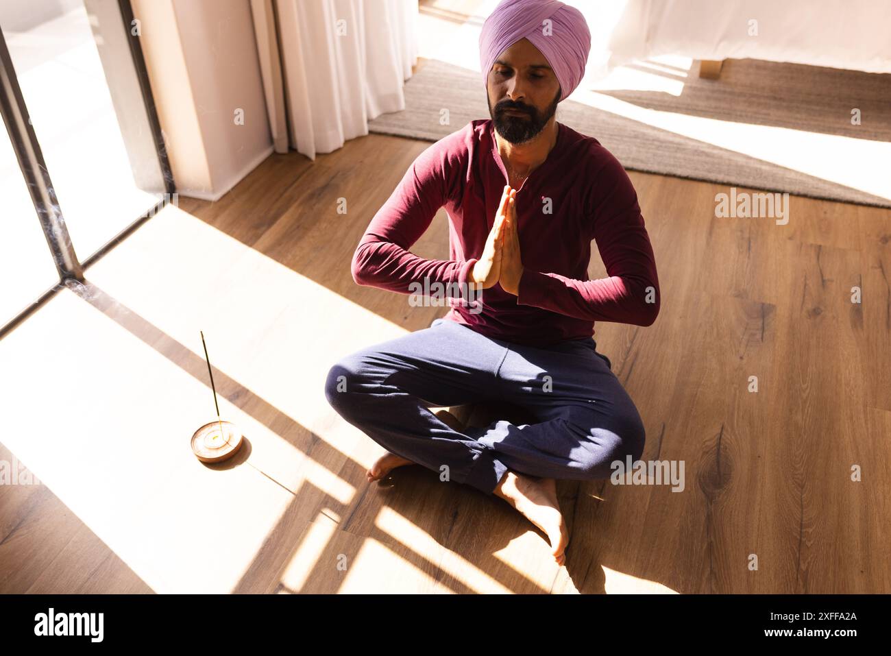Indian man sitting cross legged hi-res stock photography and images - Alamy