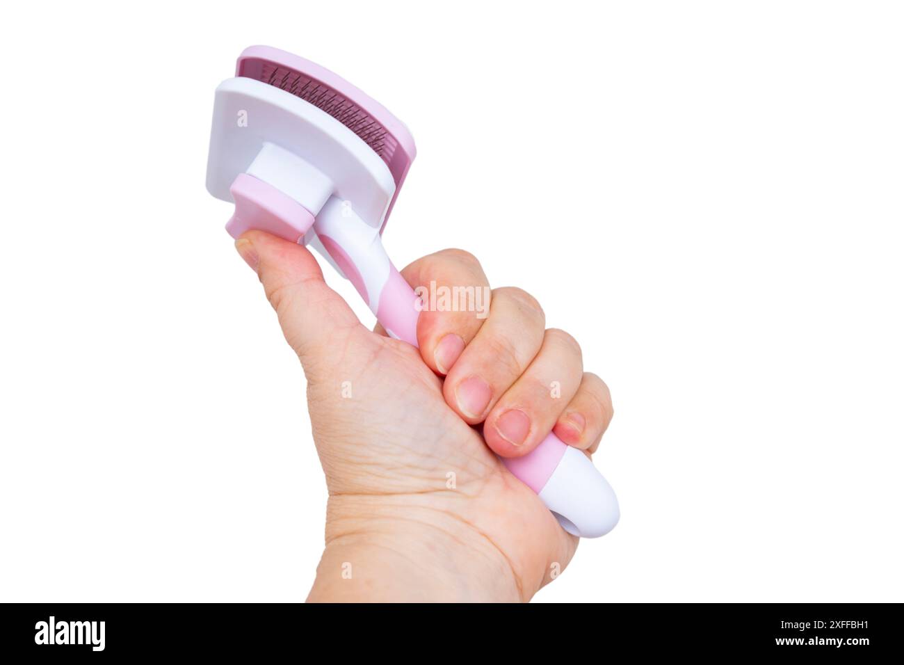 self-cleaning pink grooming tool, slicker brush in female hand ...