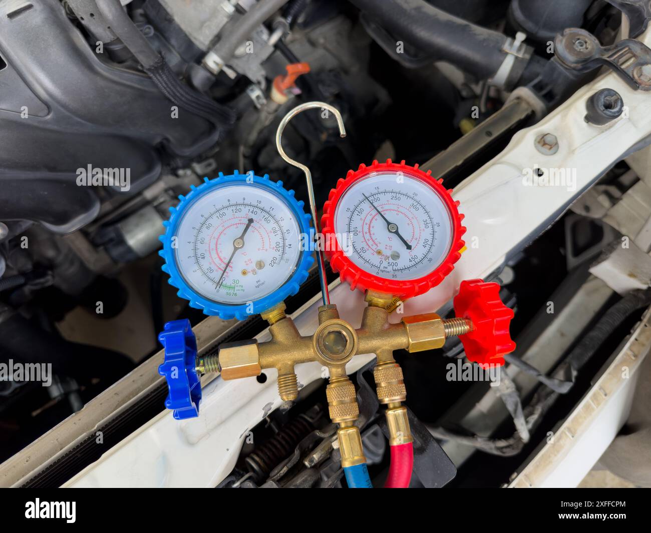 Checking A/C Pressure of a Vehicle with Measuring Gauges Tool Stock ...