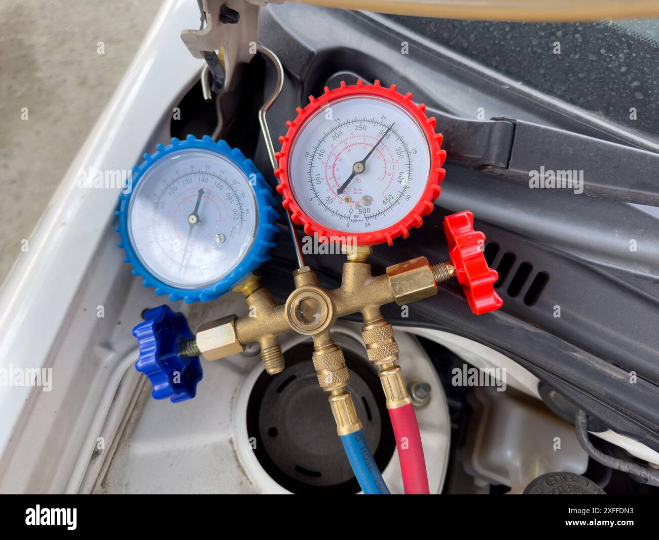 Mechanic Using A/C Manifold Gauge Set to Check Air Condition System ...