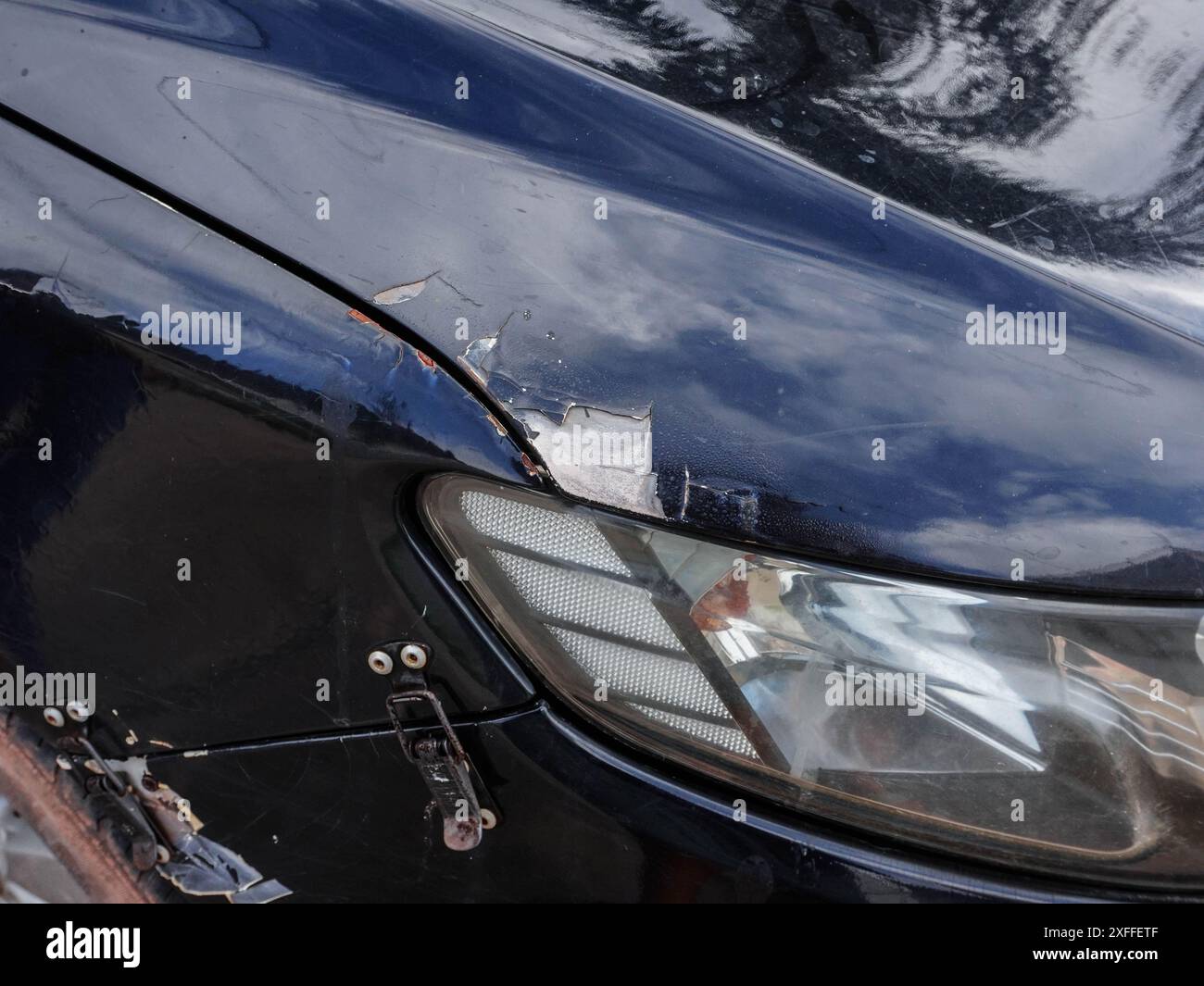 Rust and paint damage on part of the old car body. Peeling off old ...