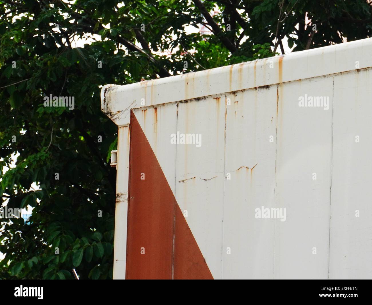 Corroded metal background. The metal wall is painted white with rust ...