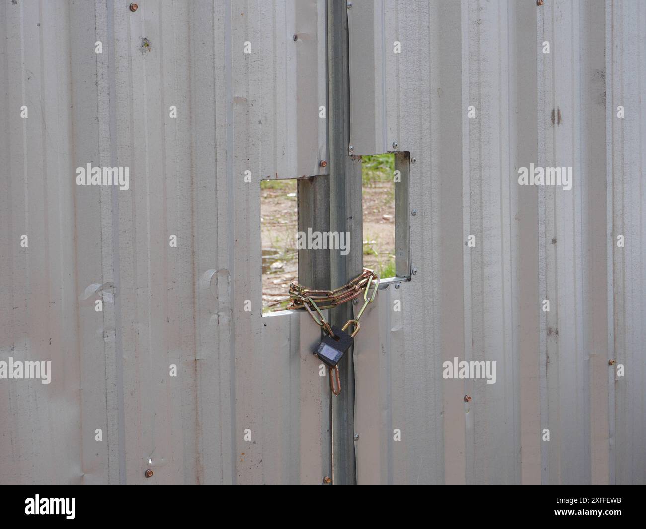 Locked Gate with Padlock and Chains Stock Photo - Alamy
