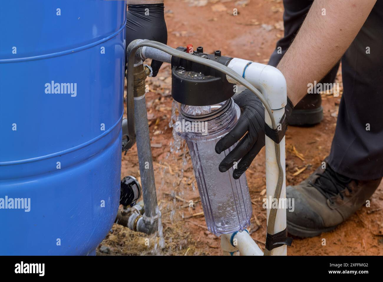 Worker performs maintenance work to replace filter in domestic water ...