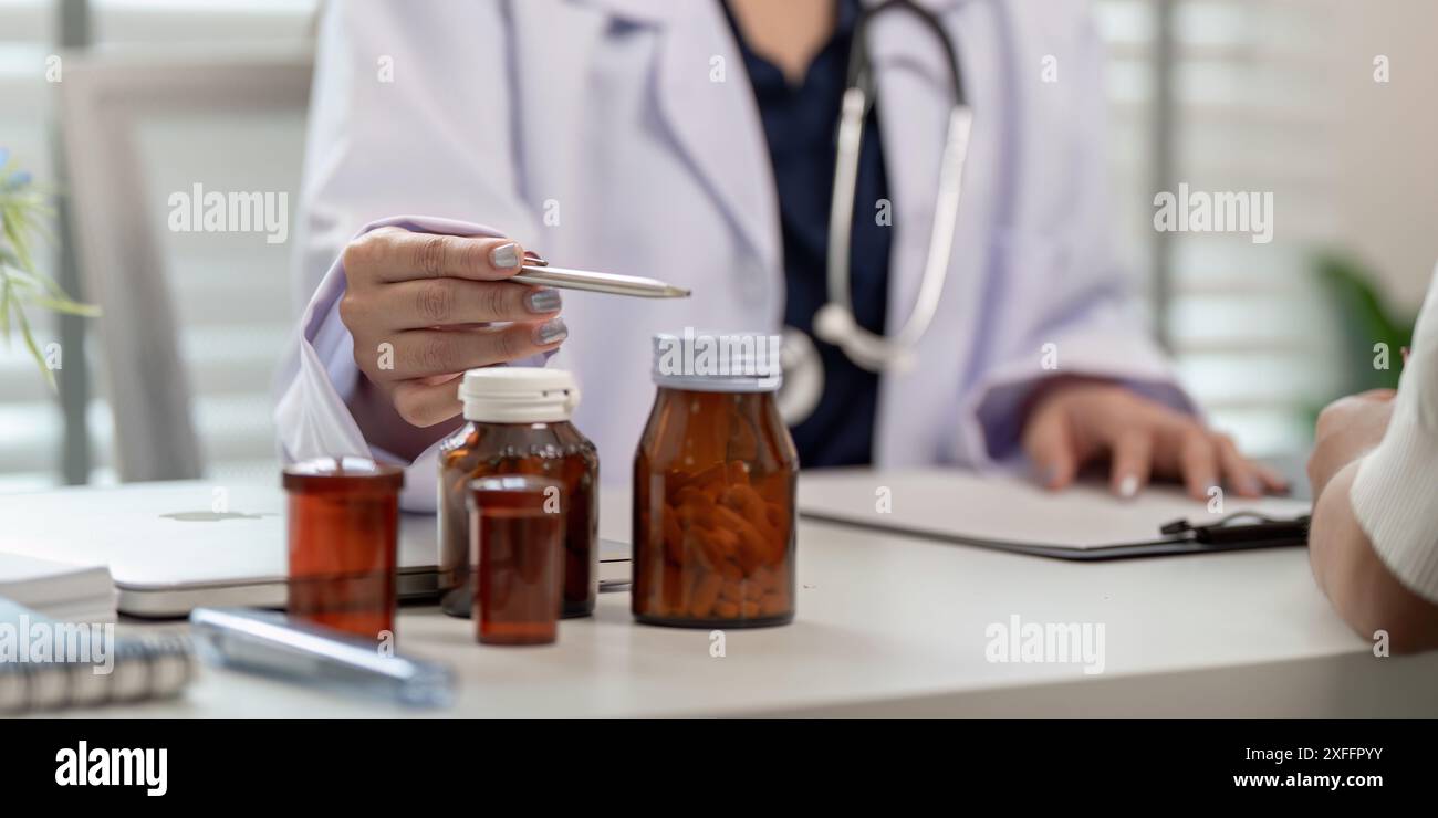 Doctor Advice Patient on Medication with Prescription Bottles on Desk ...