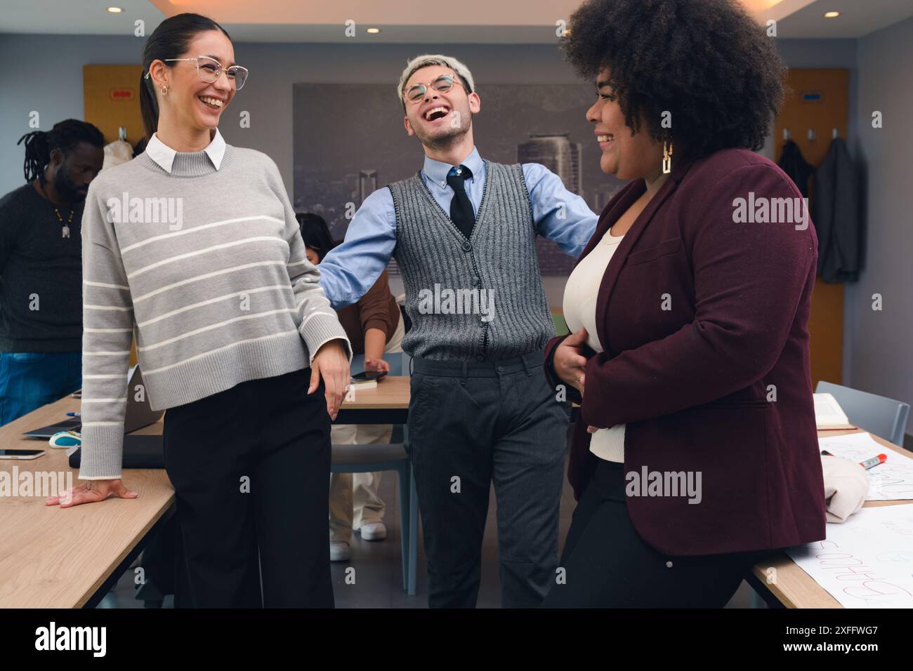 Young Man with short hair in the office standing making jokes ...