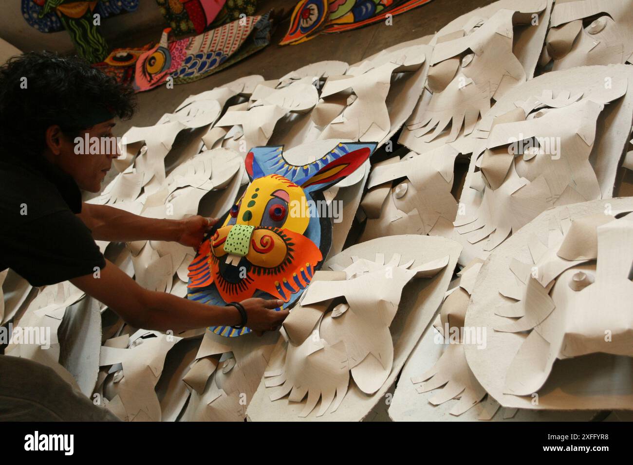 Students of Fine Art Institute of Dhaka University paint on masks ...