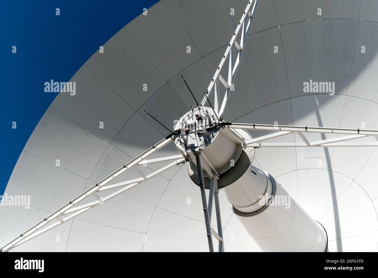 A satellite dish antenna with its feed horn and support structure ...