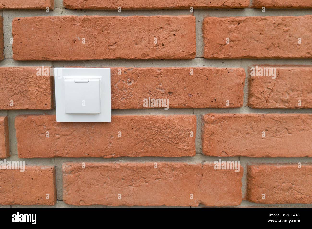 Outdoor IP44 Protected Socket on Brick Wall Stock Photo - Alamy