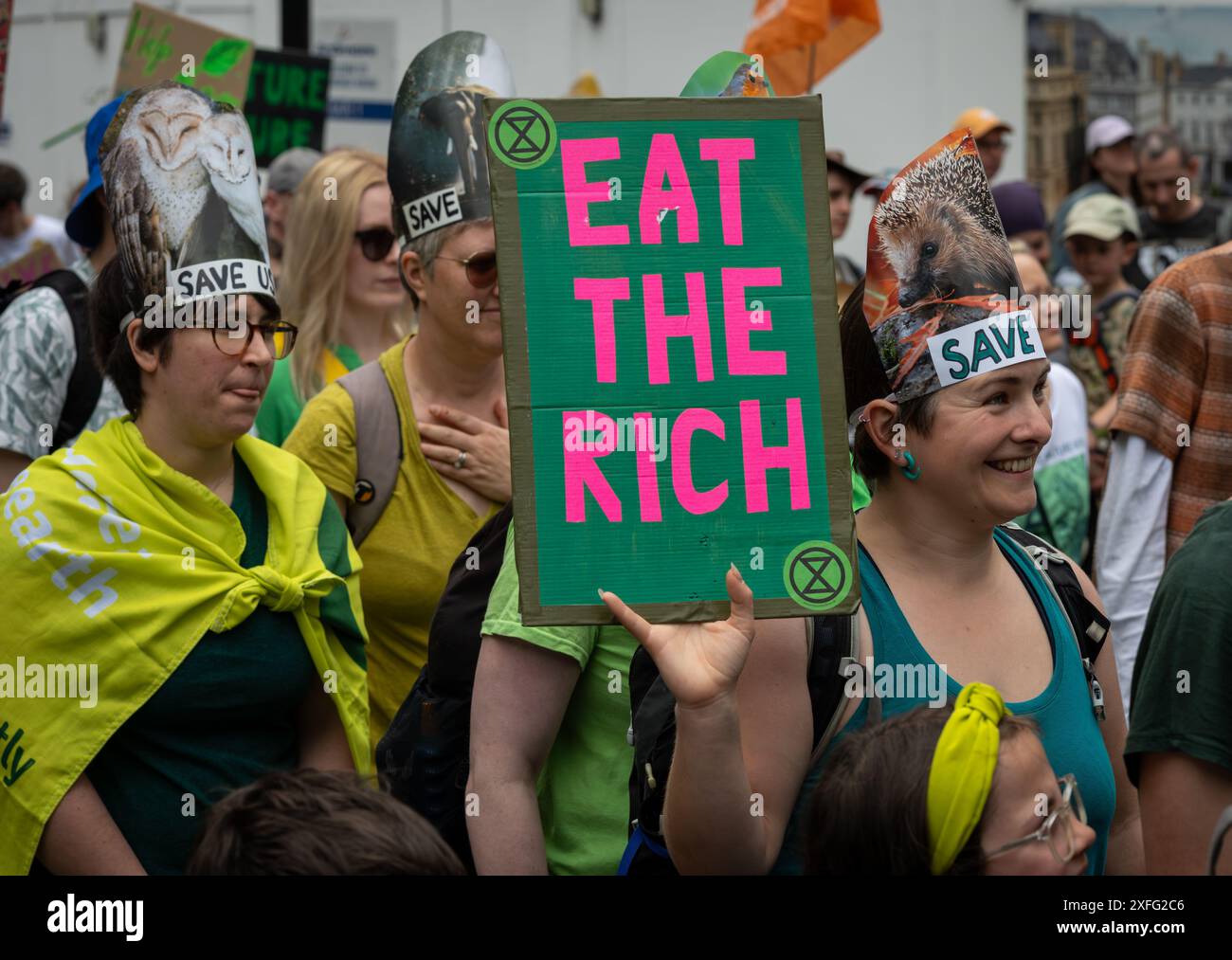 London UK - Jun 22 2024: A woman carries a placard reading "Eat the ...
