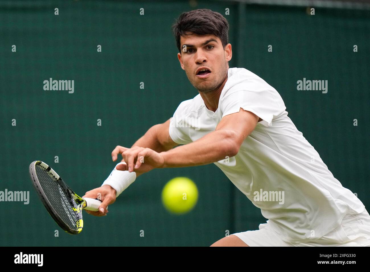 Carlos Alcaraz of Spain plays a forehand return to Aleksandar Vukic of ...