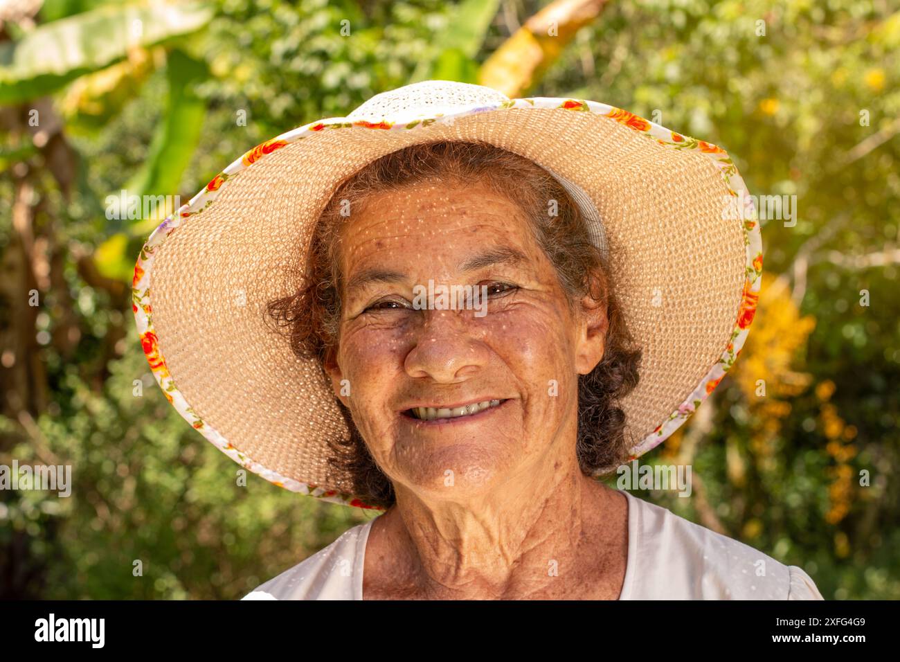 lifestyle: face portrait of an old Caucasian woman with a smiling hat ...