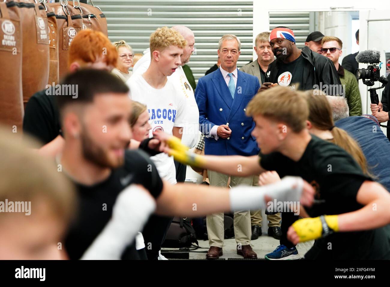Reform UK leader Nigel Farage (centre) and boxer Derek Chisora (centre ...