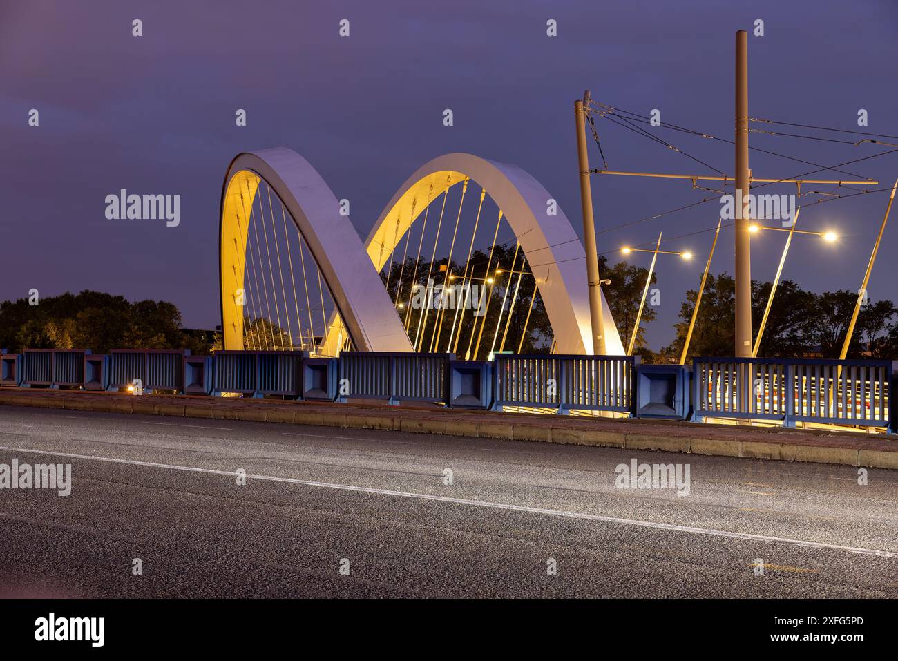 illuminated tram stop with a bridge in Lyon at night Stock Photo - Alamy