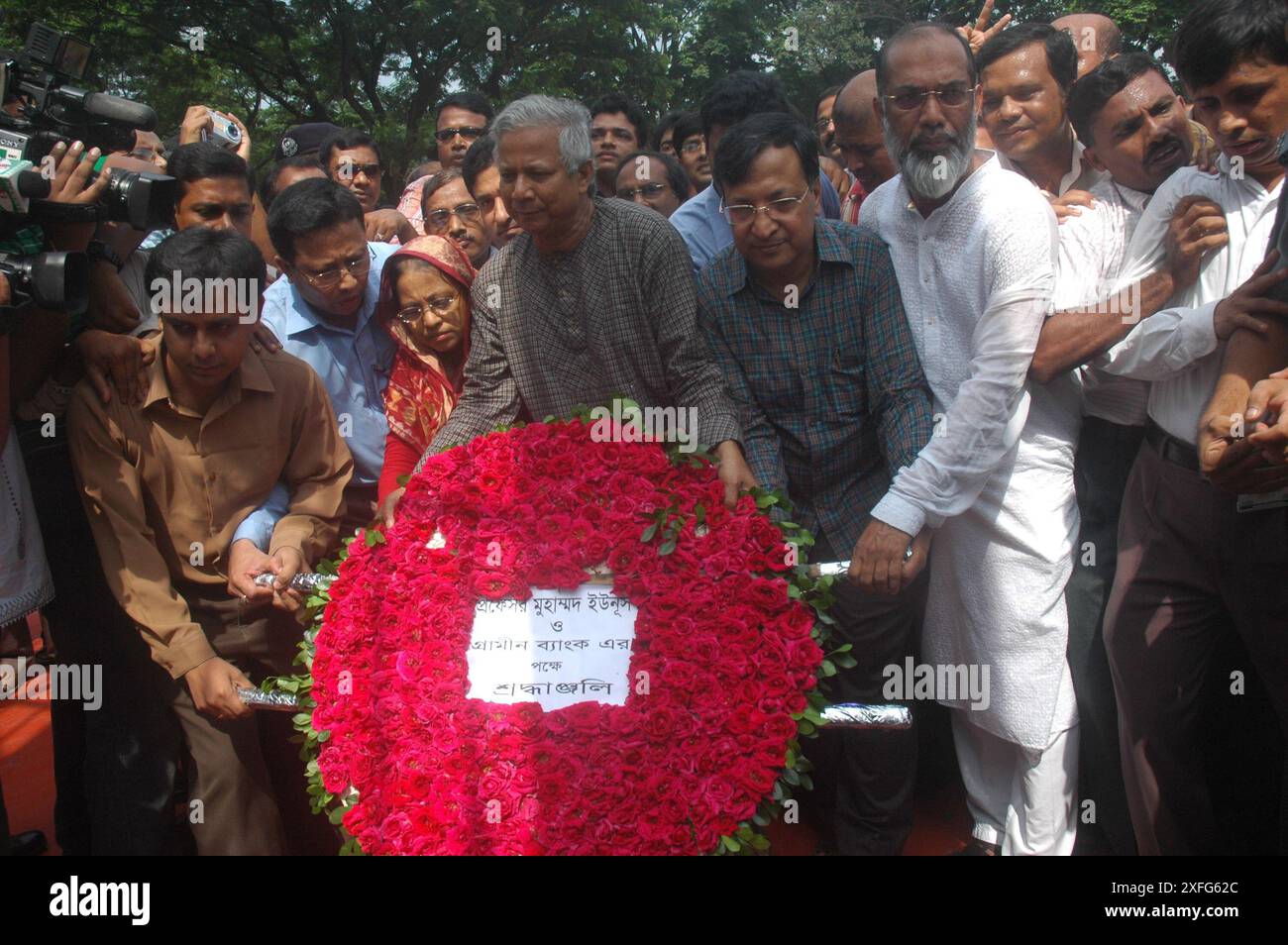 Bangladeshi Nobel Peace Prize winner Muhammad Yunus (C) is accompanied ...