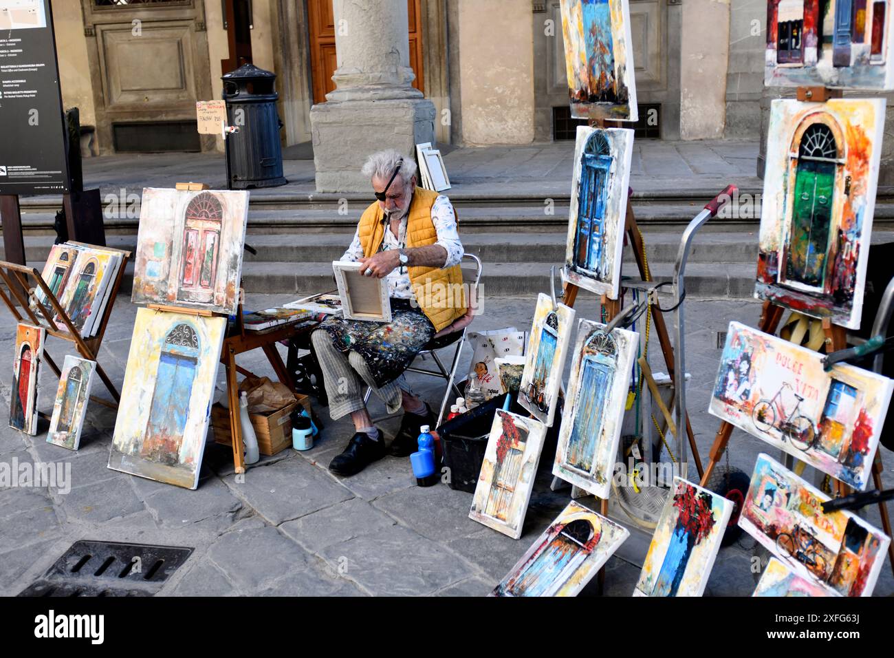 Italian street artist working on the streets of Florence in Italy Stock ...