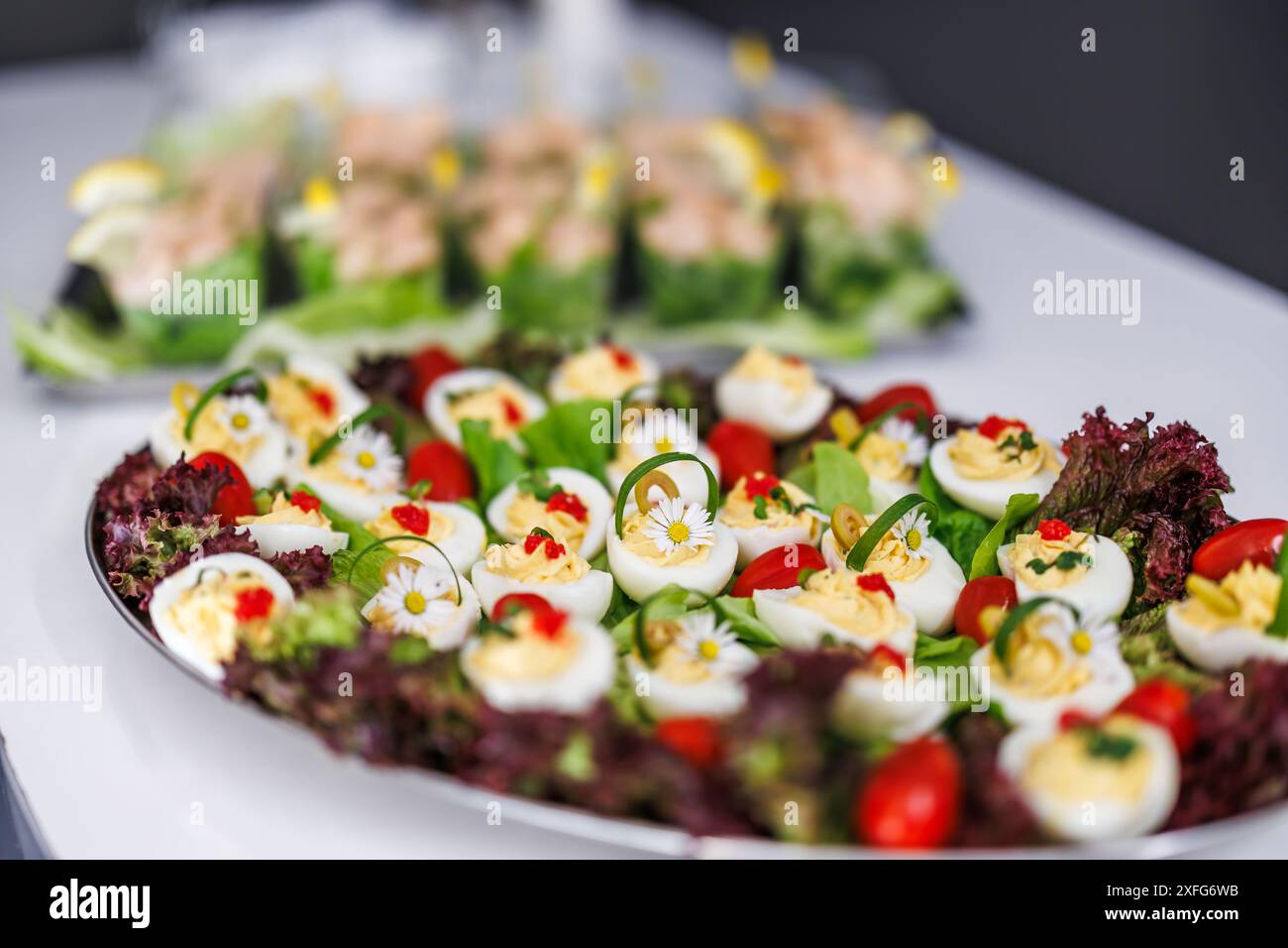 Colorful appetizer platters featuring deviled eggs decorated with daisy ...