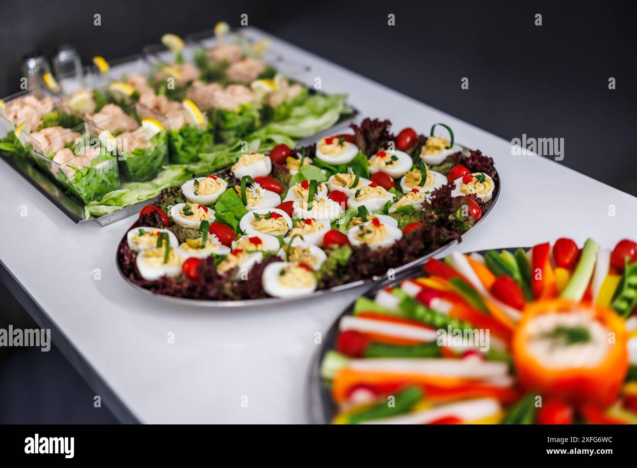 Colorful appetizer platters featuring deviled eggs and fresh vegetables ...