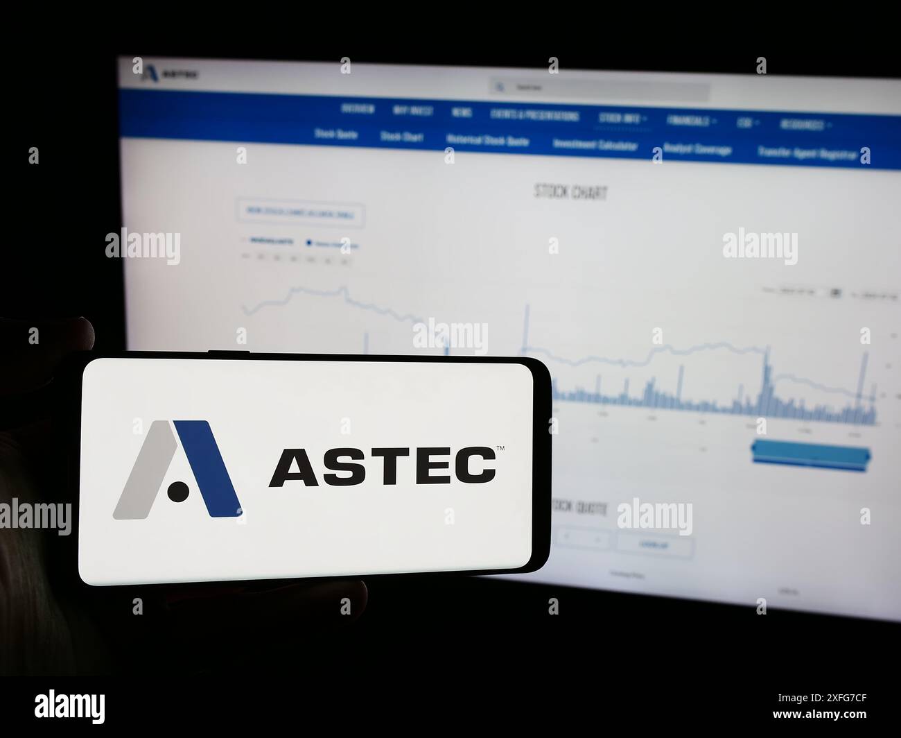 Person holding mobile phone with logo of American equipment company ...