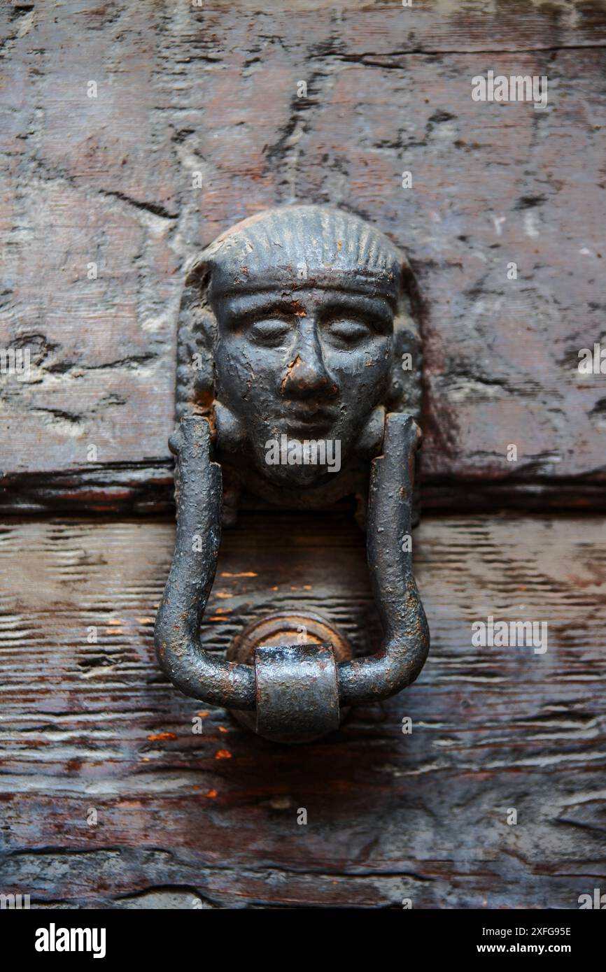 Antique bronze knocker adorning an old wooden doo Stock Photo - Alamy