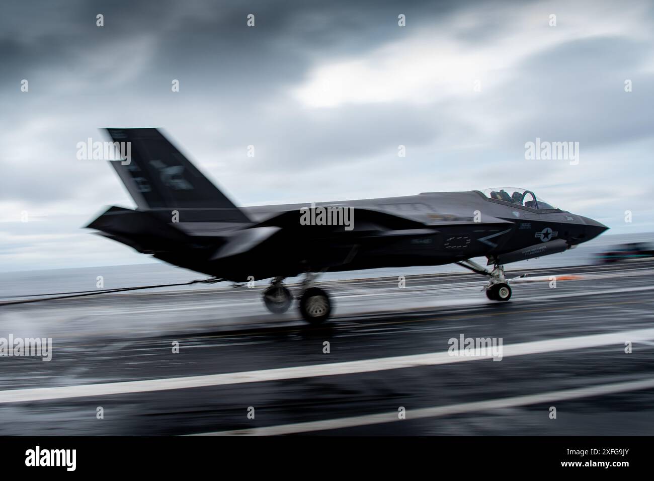 An F-35C Lightning II, attached to Strike Fighter Squadron (VFA) 147, lands on the flight deck ...