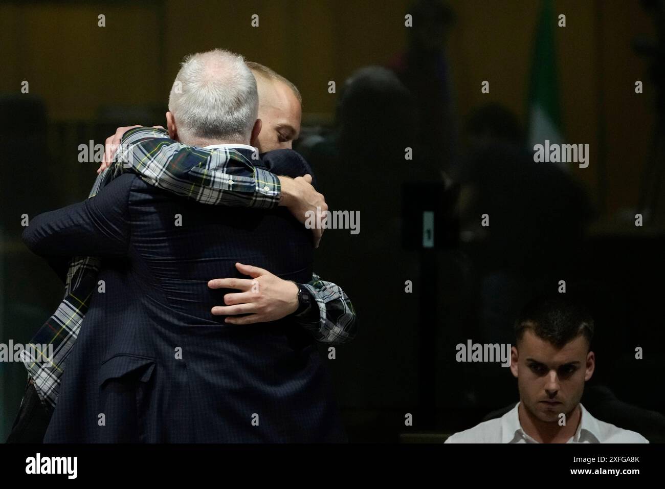 Ethan Elder, left, back to camera, father of Finnegan Lee Elder, hugs ...