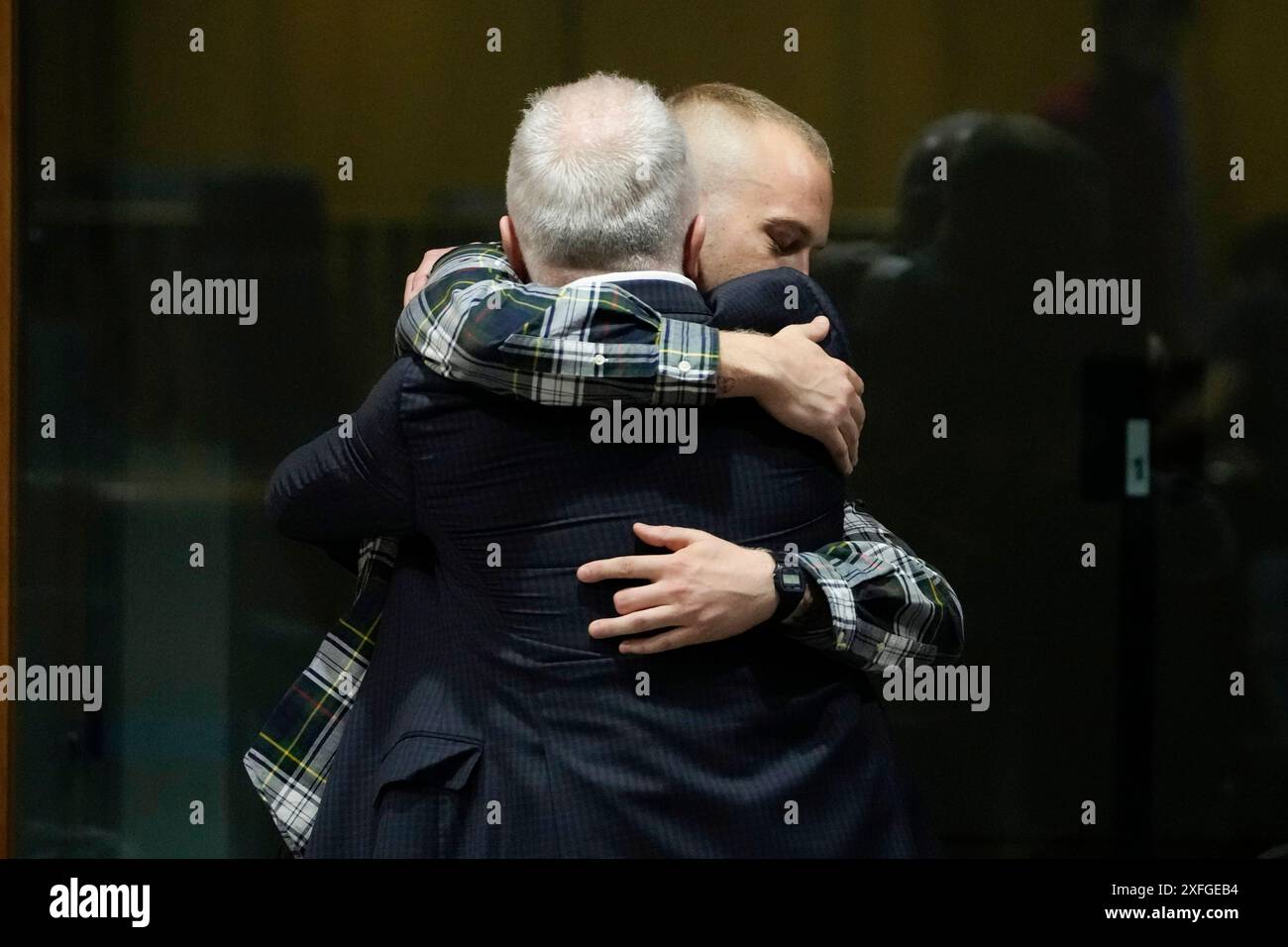 Ethan Elder, left, father of Finnegan Lee Elder hugs his son before the ...
