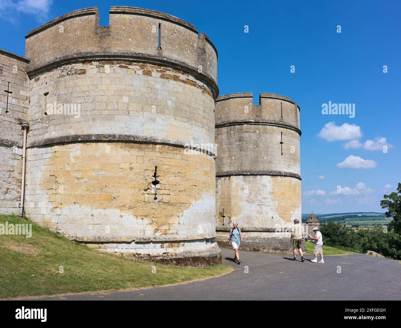 Visitors beside the twin round towers at Rockingham castle, Corby ...