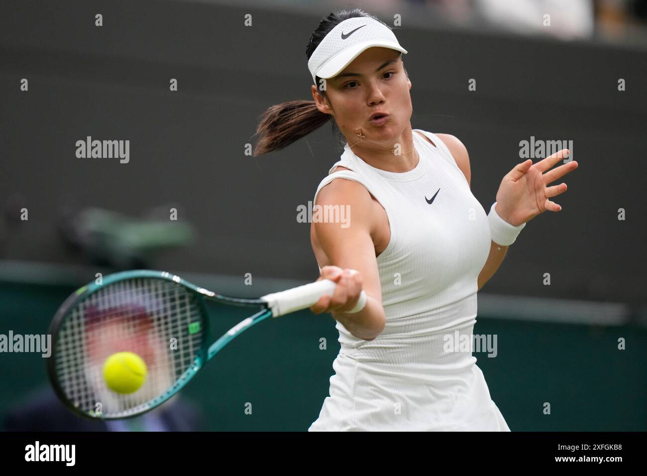 Emma Raducanu of Britain plays a forehand return to Elise Mertens of ...