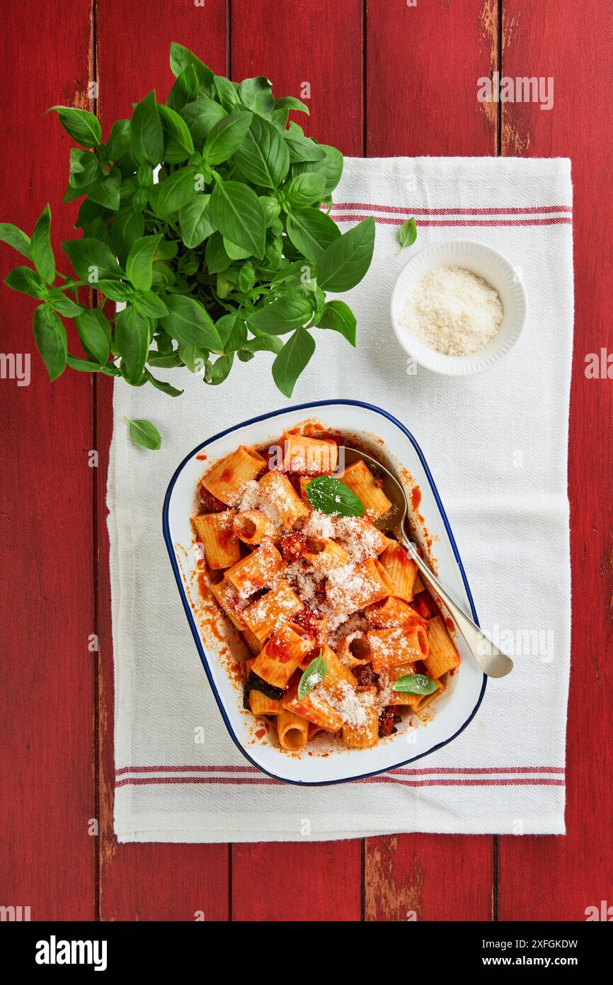 Pasta Rigatoni with parmesan cheese, tomato passata sauce and basil in ...