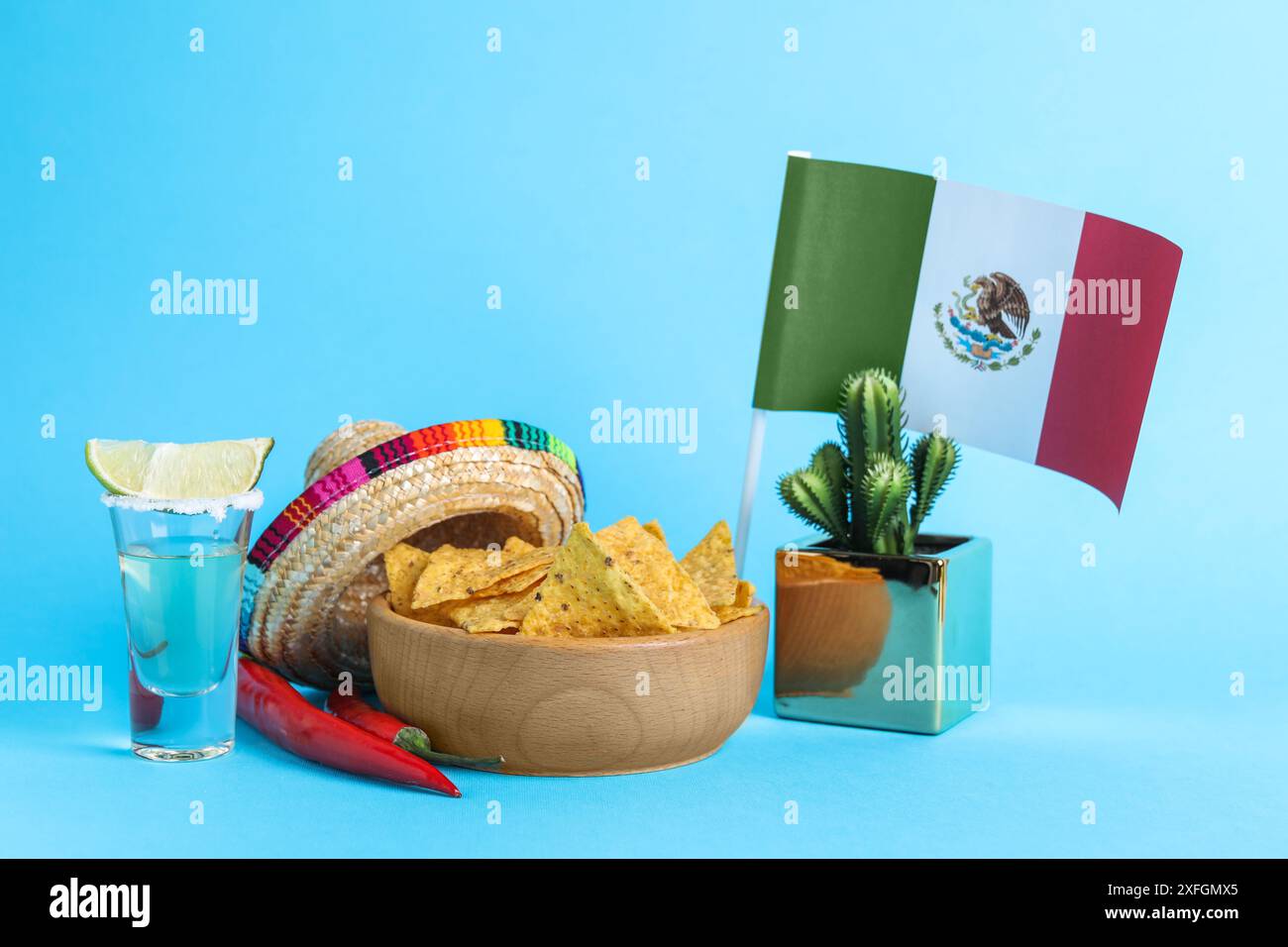 Mexican flag, sombrero hat, chili peppers, nachos chips and tequila on ...